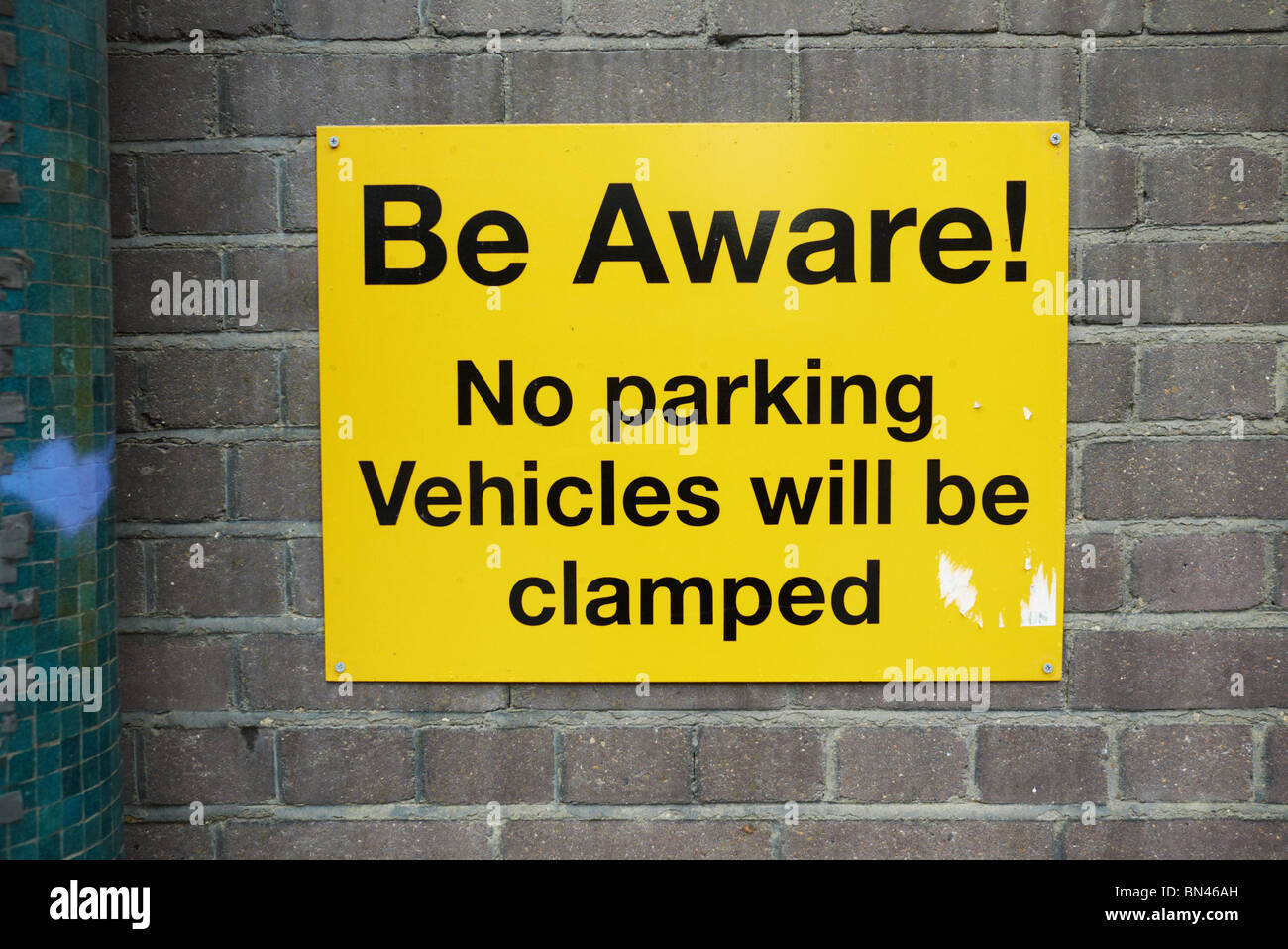 beware vehicle car clamping sign in london england uk Stock Photo - Alamy