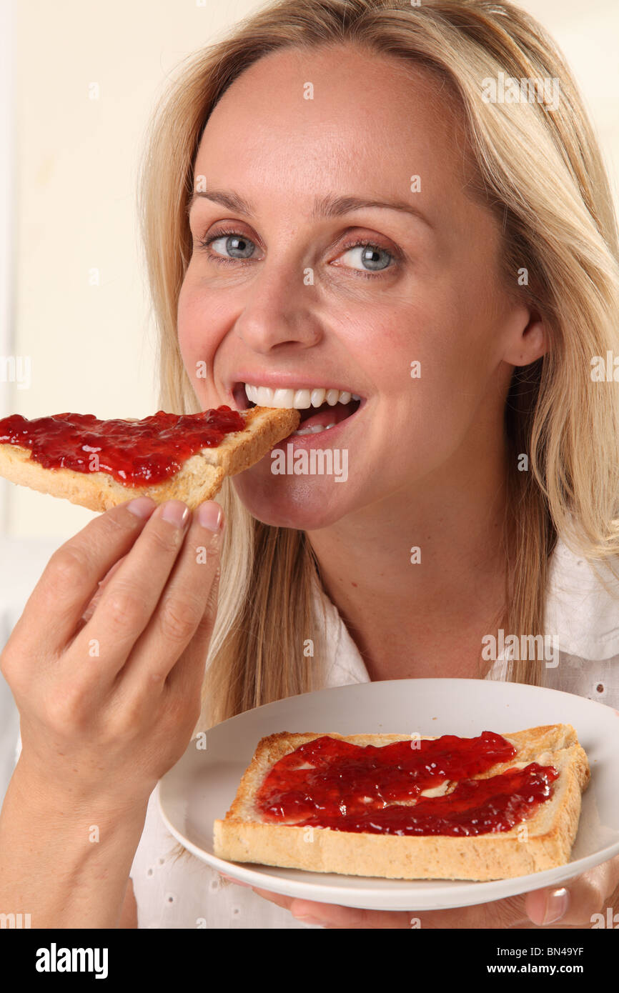 WOMAN EATING TOAST Stock Photo - Alamy