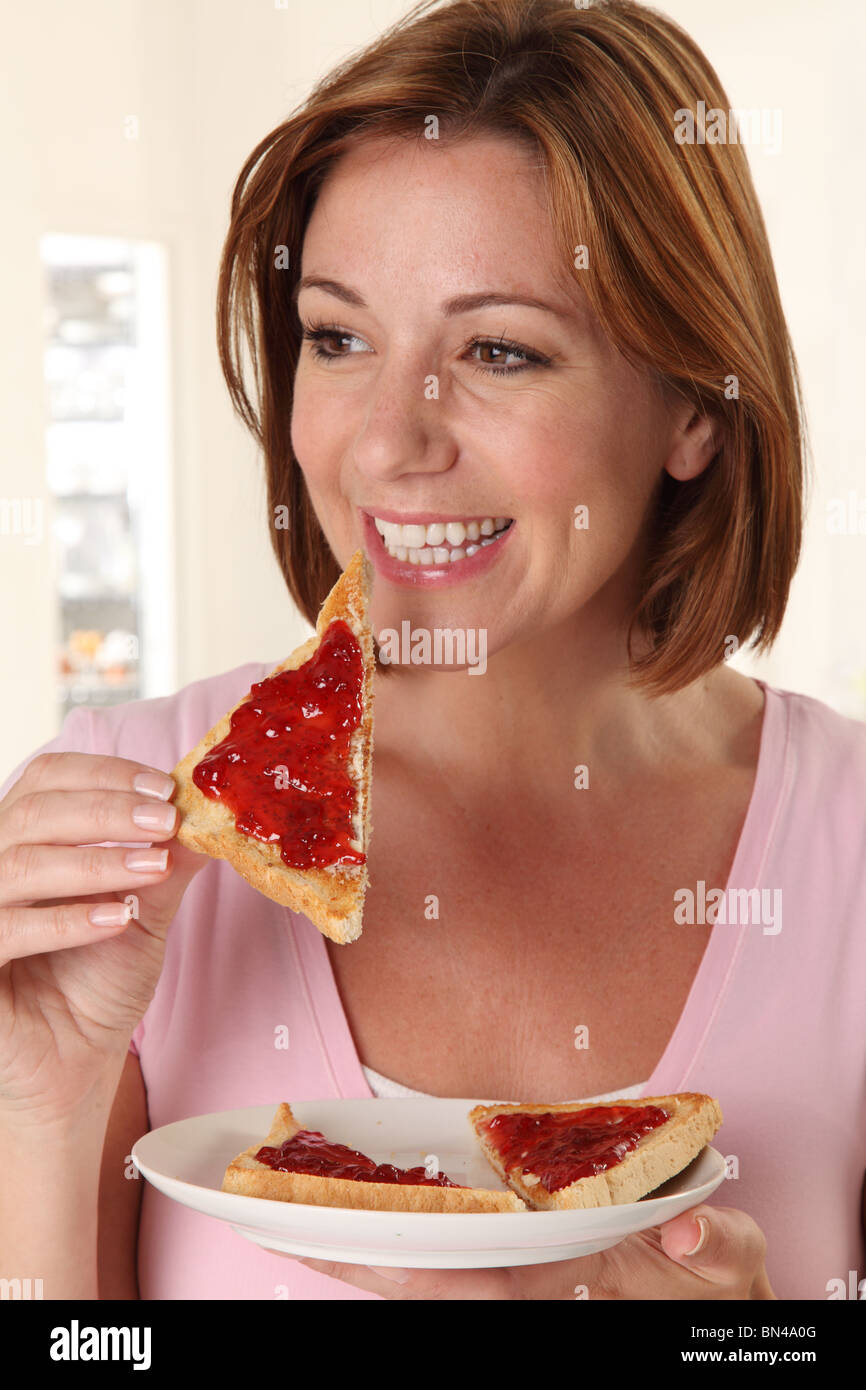 WOMAN EATING TOAST Stock Photo - Alamy