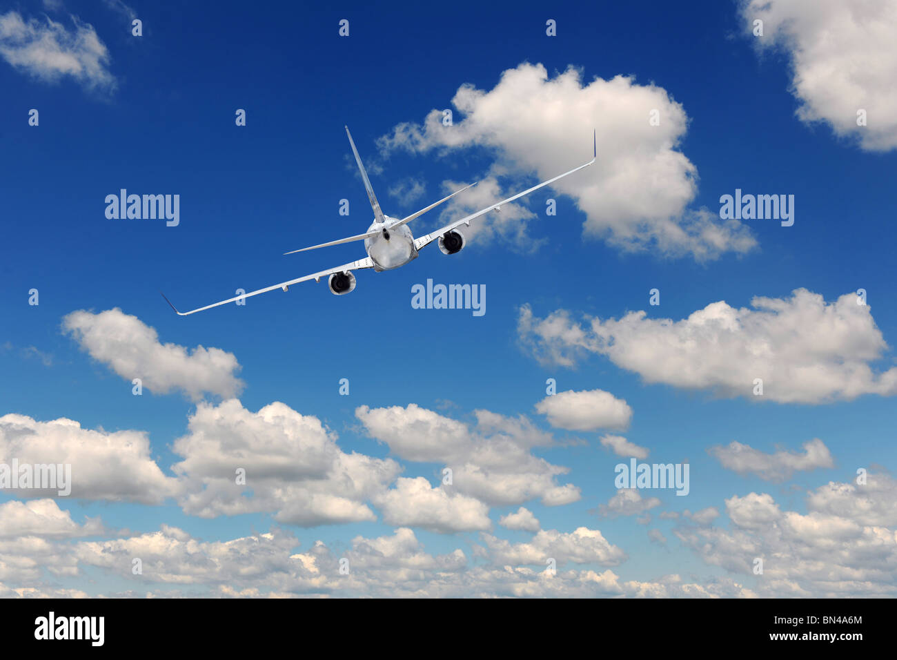 Airliner flying over blue sky with clouds Stock Photo - Alamy