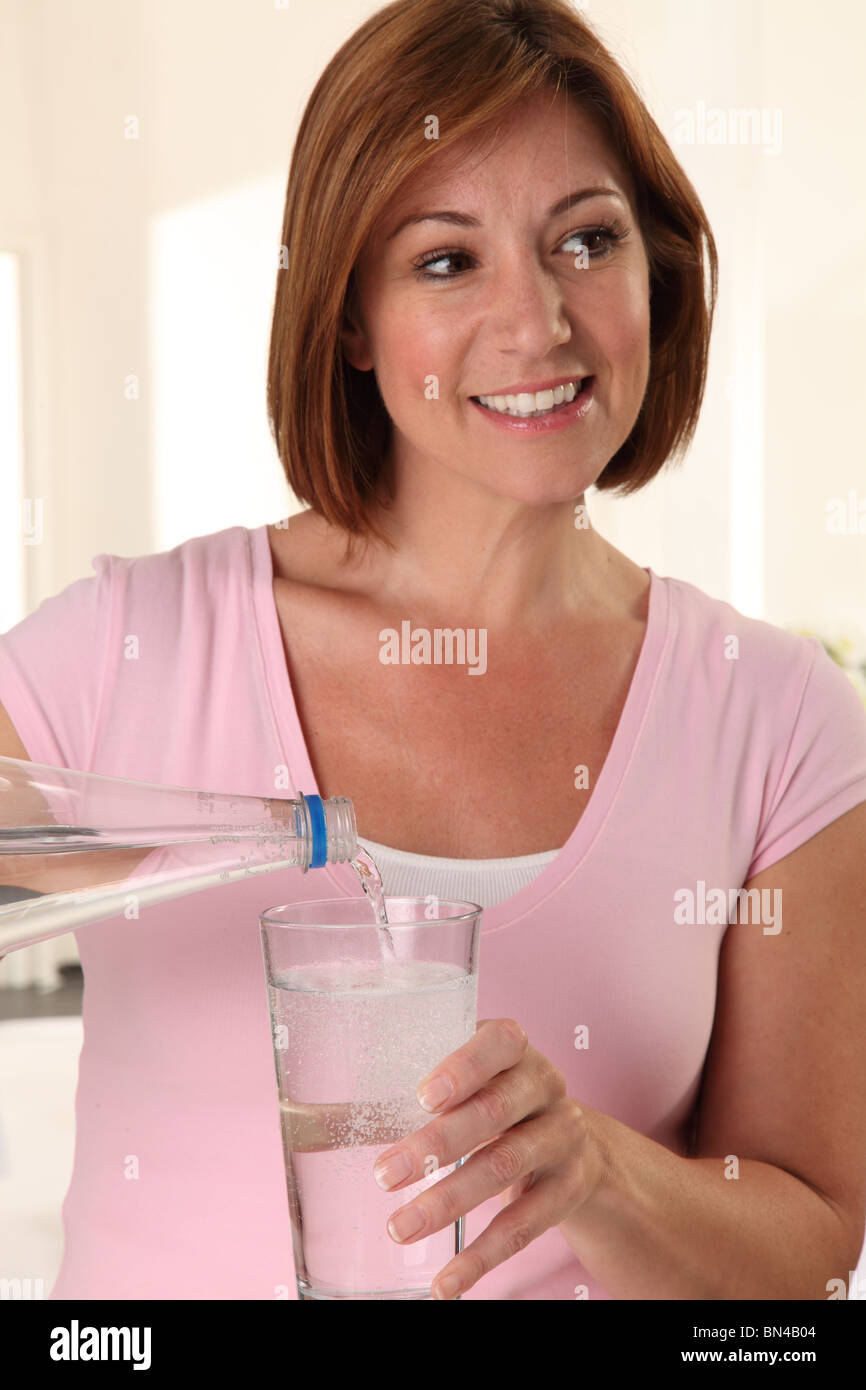 WOMAN POURING WATER Stock Photo - Alamy