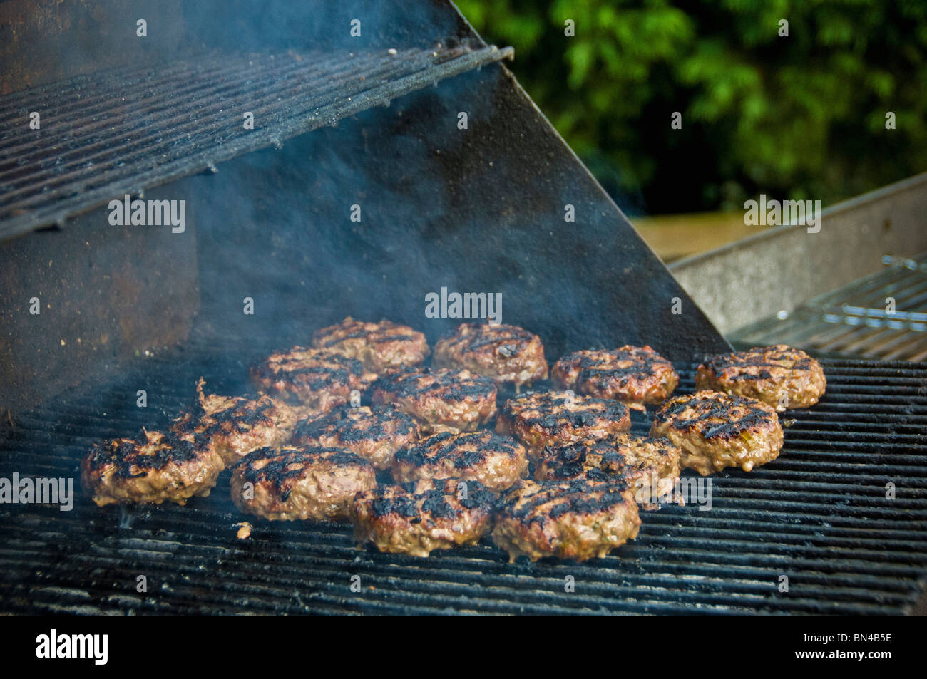 Burgers cooking on barbecue outside Stock Photo - Alamy