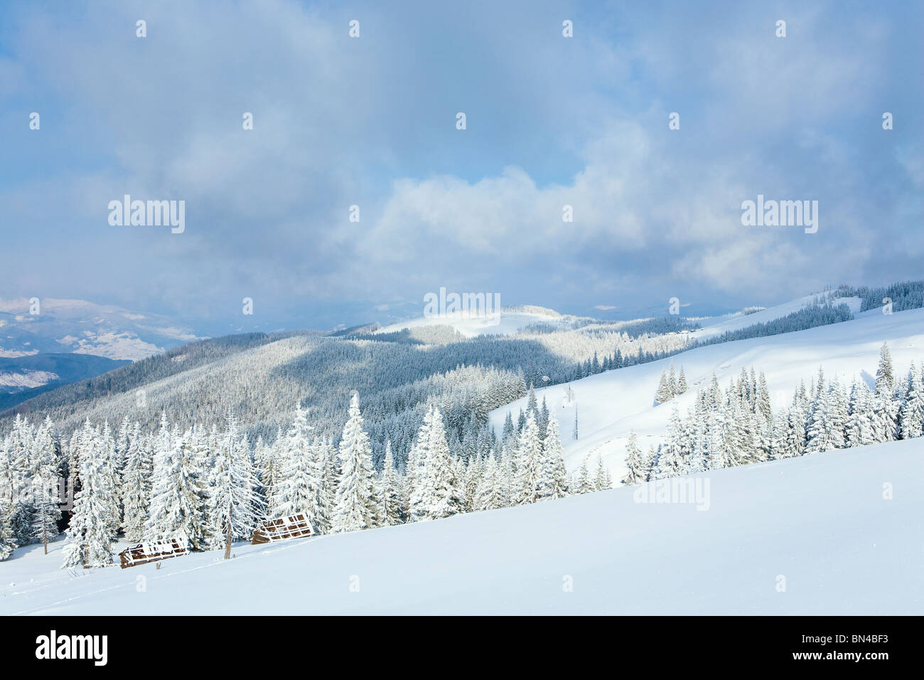 winter calm mountain landscape with sheds and mount ridge behind (Kukol ...
