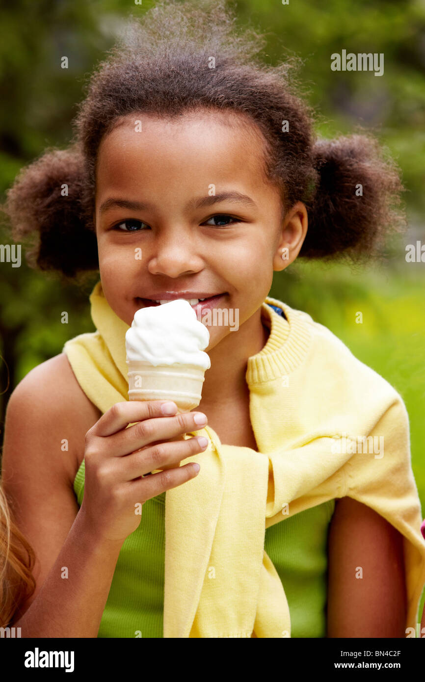 Portrait of pretty girl eating ice-cream Stock Photo - Alamy