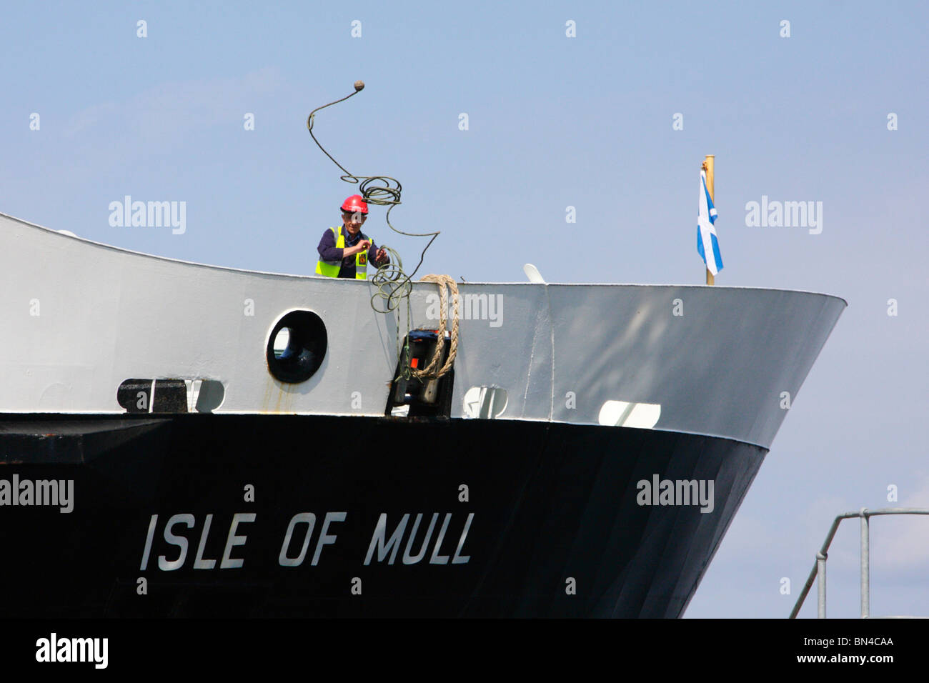 Old deckhand throwing a line from a ferry Stock Photo - Alamy