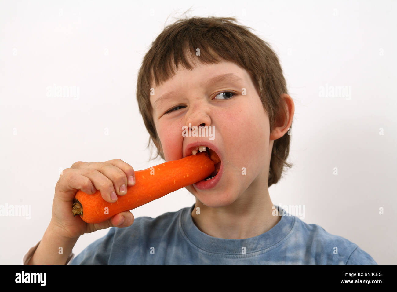 A boy biting a carrot, Berlin, Germany Stock Photo - Alamy