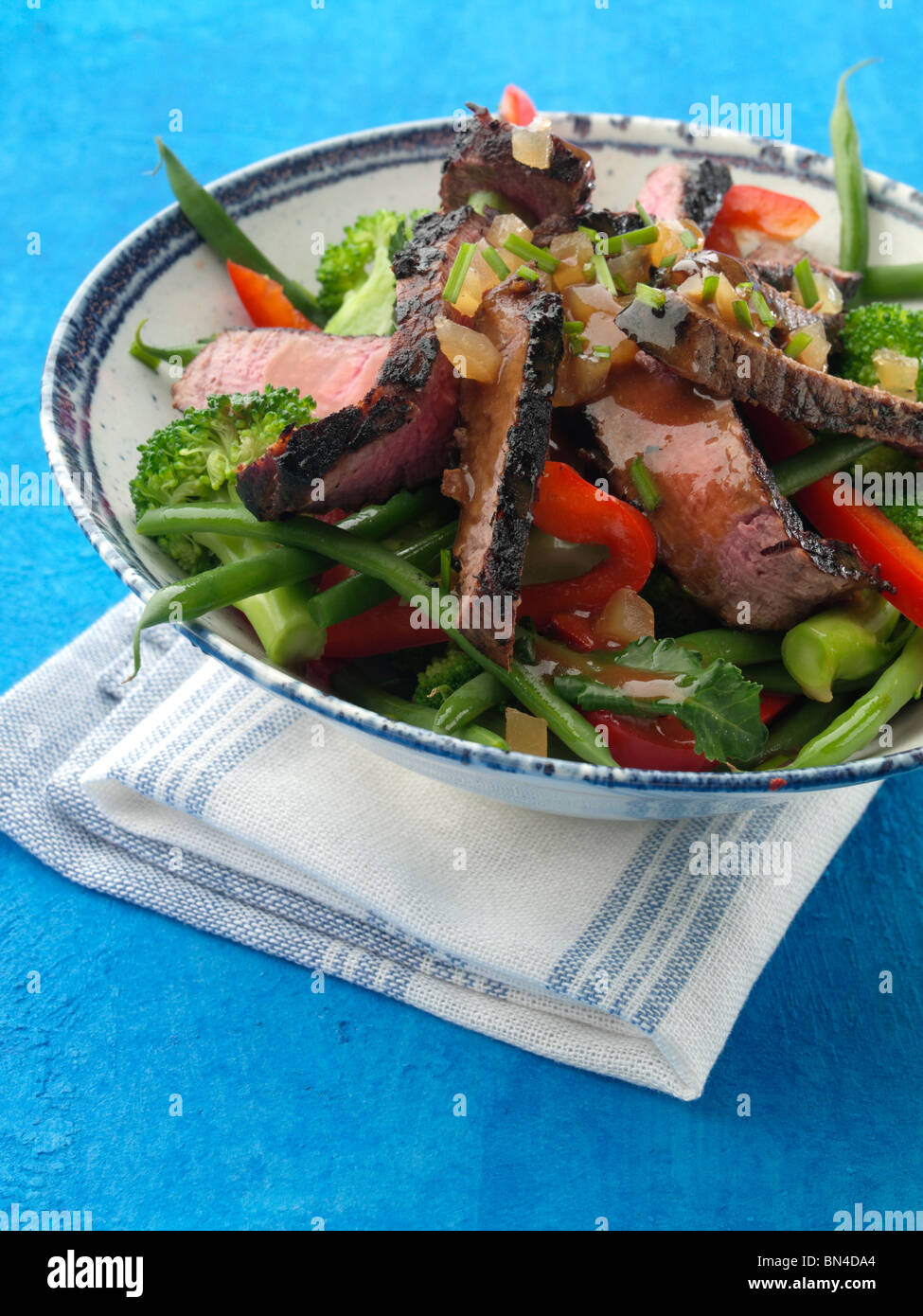 Chargrilled fillet steak strips with vegetable salad honey ginger ...
