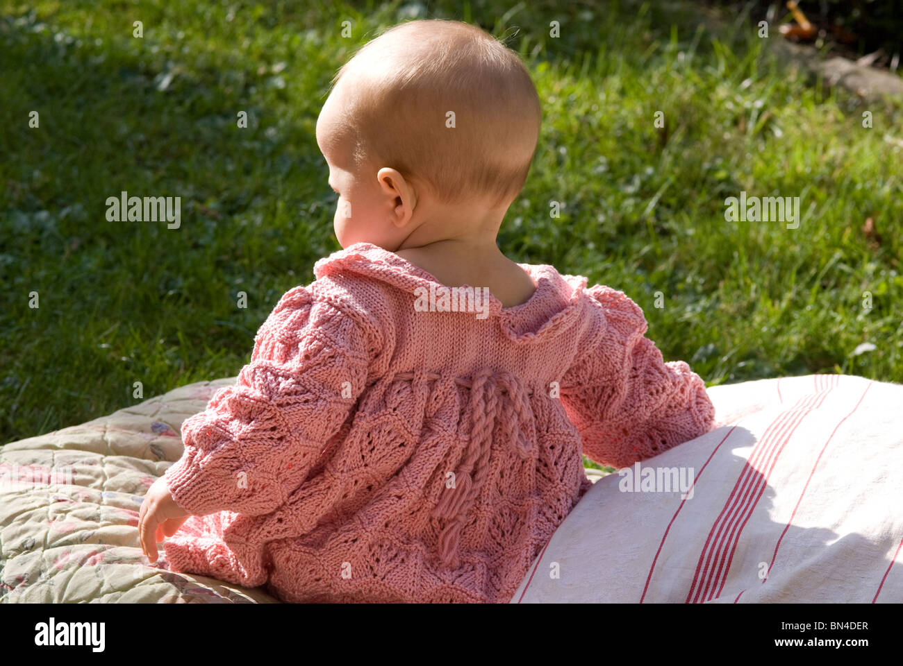 Baby sitting outside garden pink dress hi-res stock photography and ...