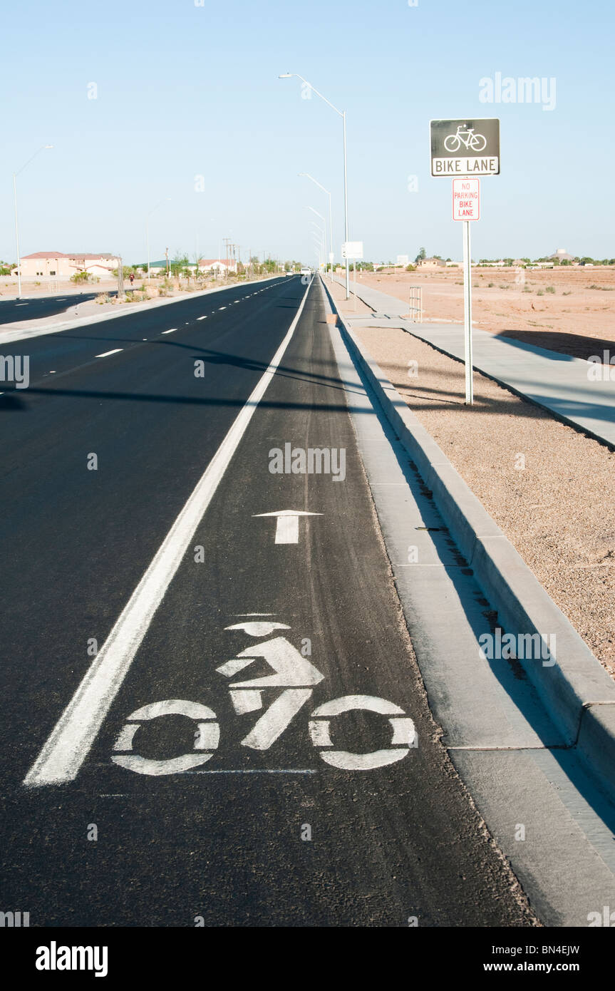 Bike lane painted on a city street with a no parking sign on the side ...