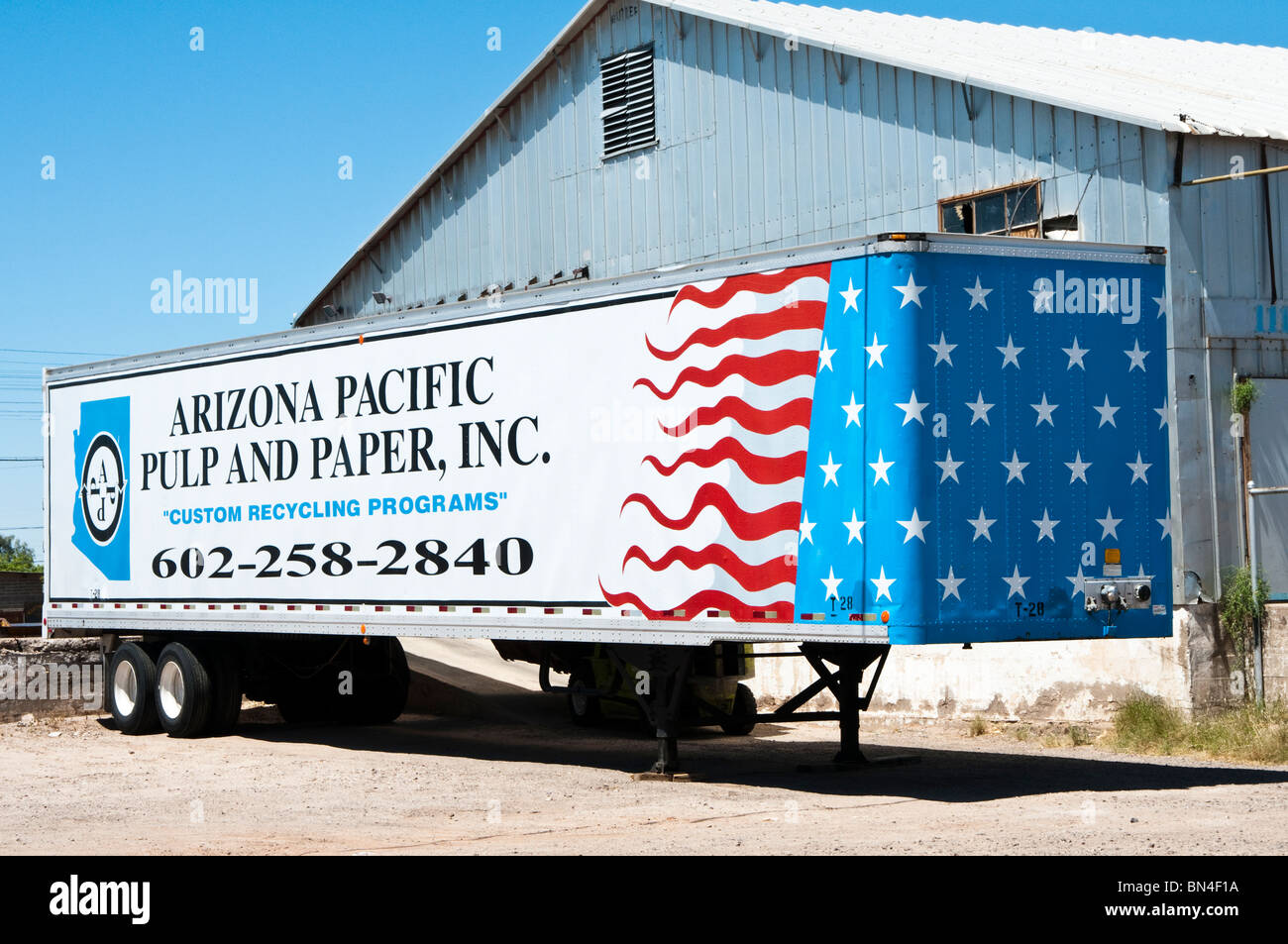 A paper recycling trailer is parked next to a warehouse Stock Photo - Alamy