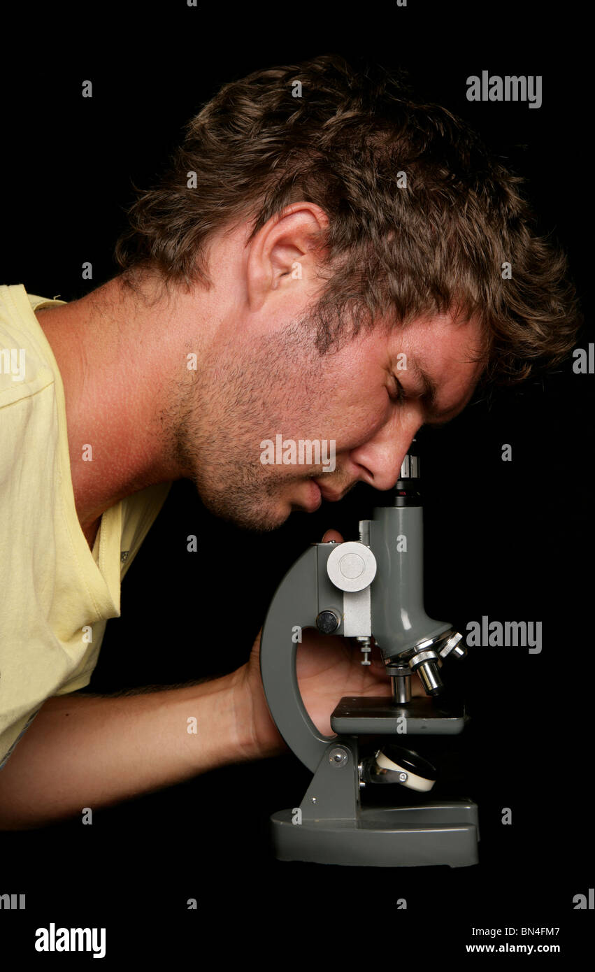 Man with microscope on black background Stock Photo - Alamy