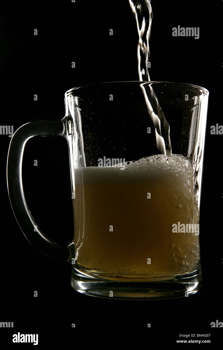 Cider being poured into pint glass in studio Stock Photo - Alamy