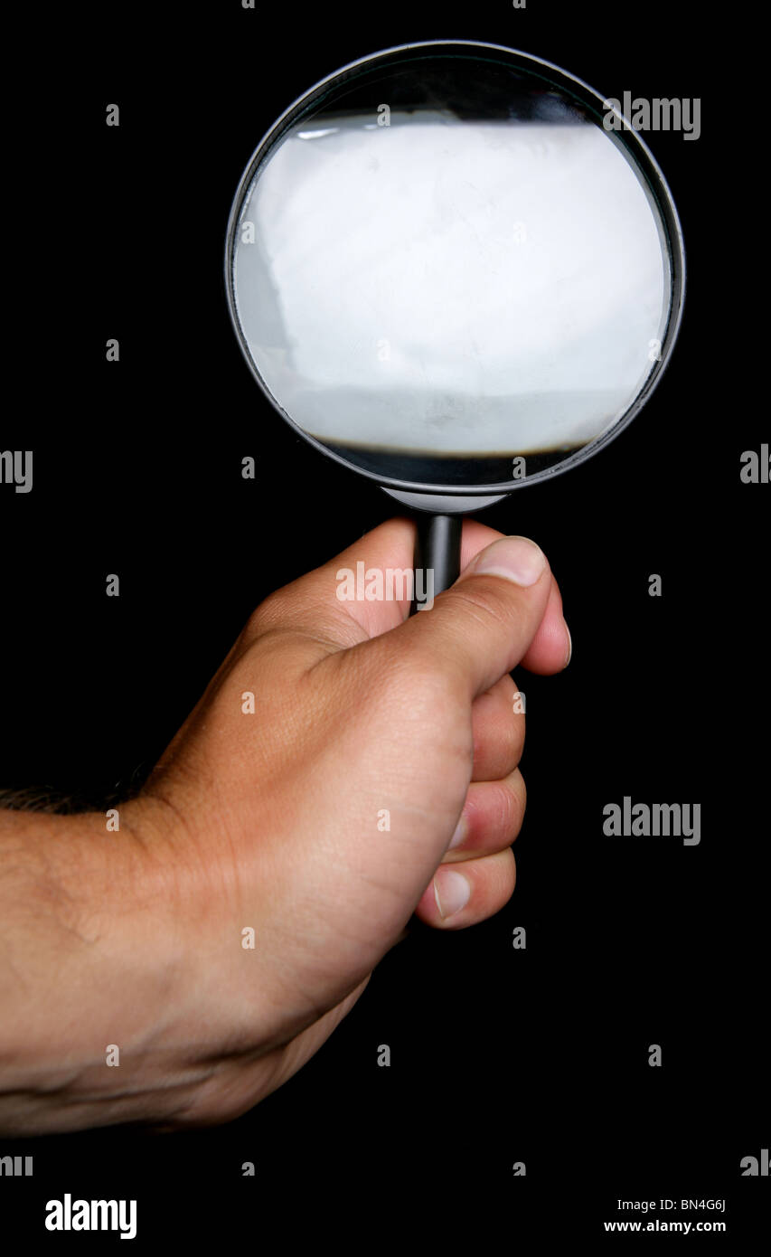 Man holding Magnifying glass in studio Stock Photo - Alamy