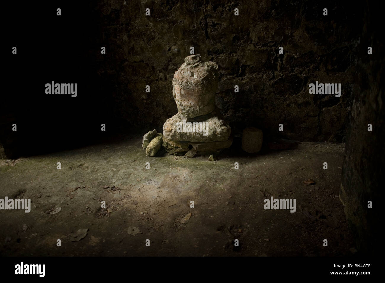 A Mayan God sculpture in lotus position on a building at the ancient ...