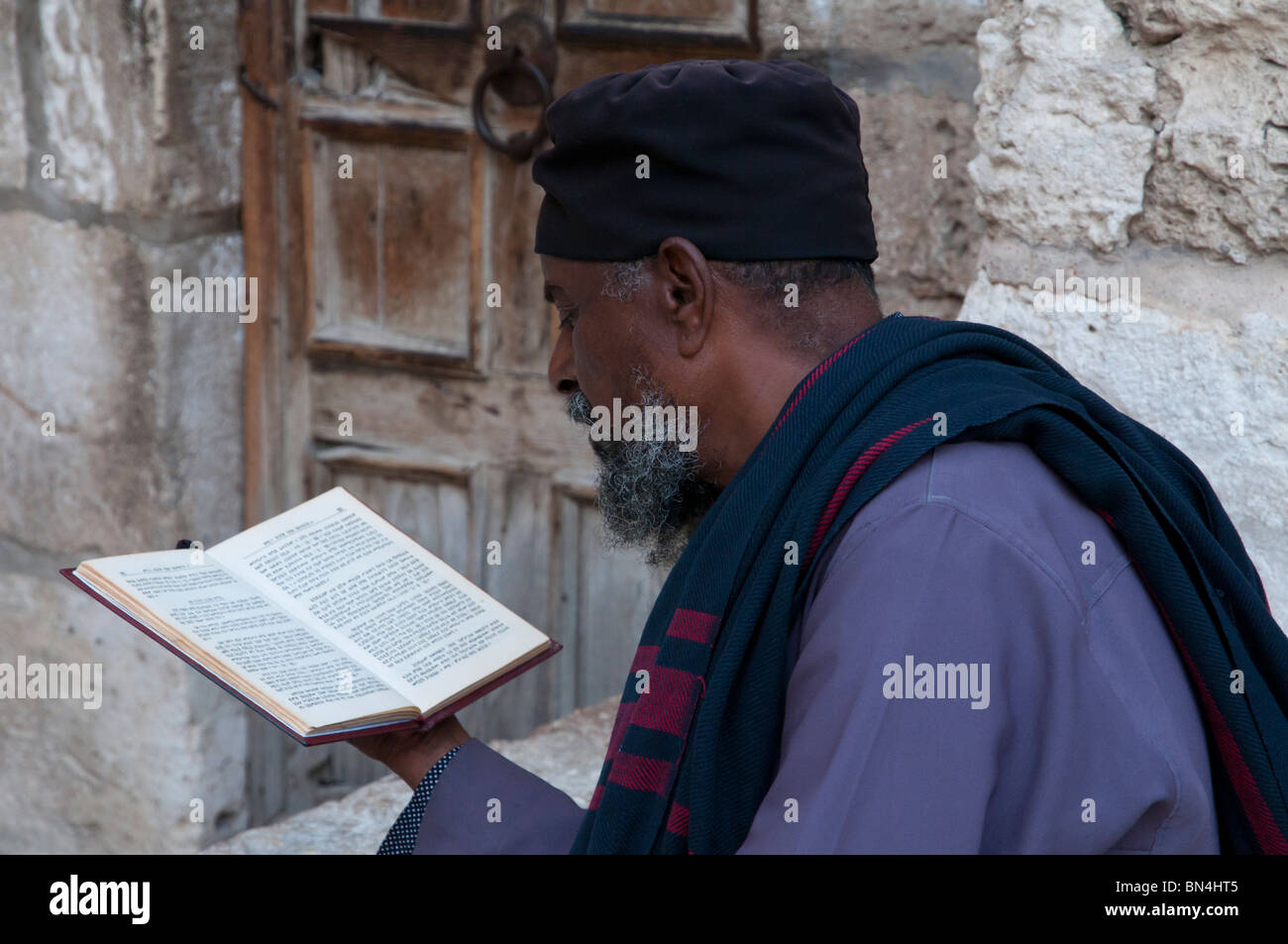 Jerusalem Old City. Ethiopian christian priest reading outside Holy ...