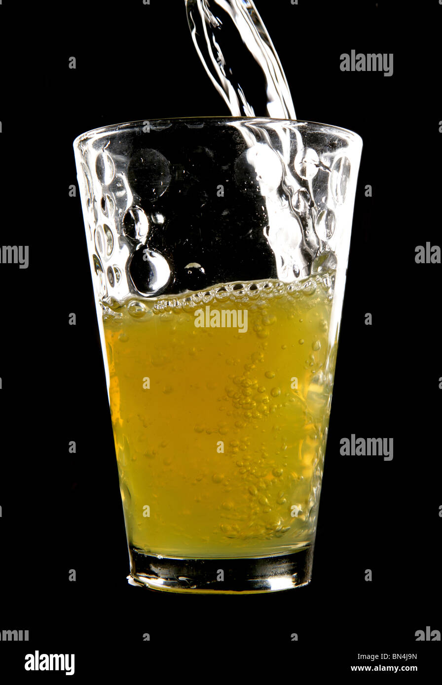Orange squash being poured in studio Stock Photo - Alamy