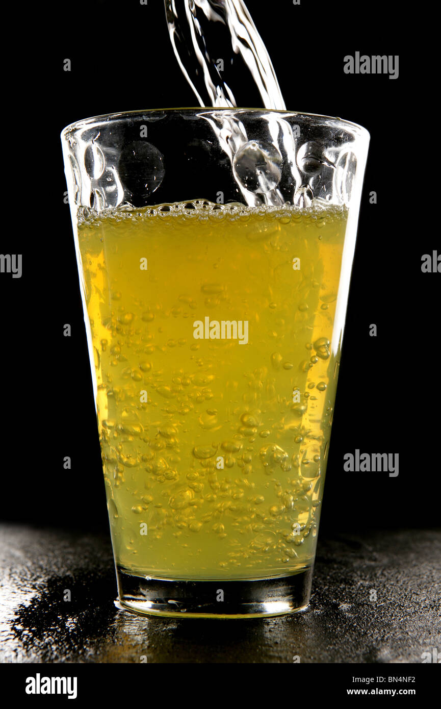 Orange squash being poured in studio Stock Photo - Alamy