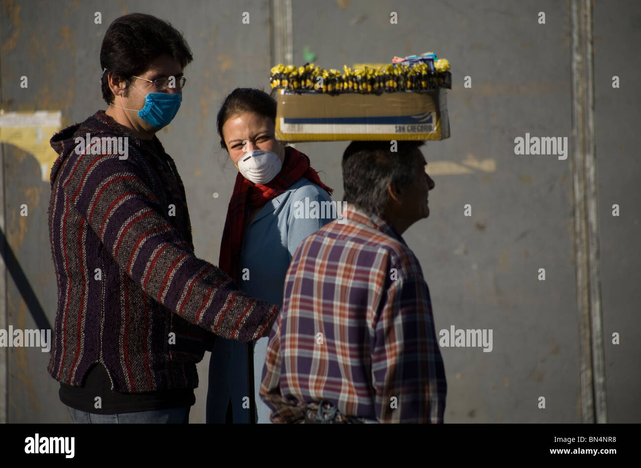 A couple wear masks as a precaution against swine flu in the Zocalo ...