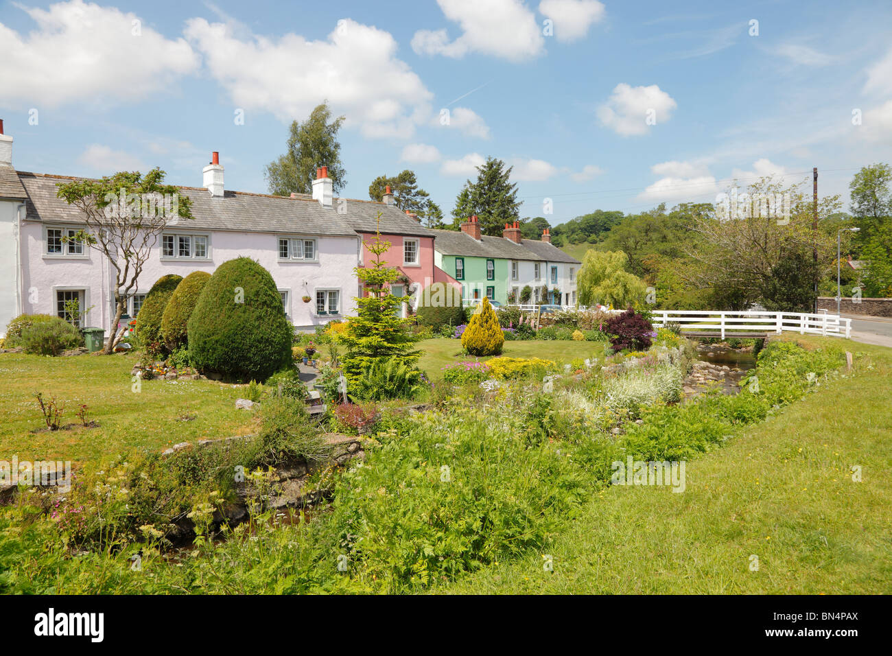 Colourful cottages with stream in front. In Calbeck, The Lake District ...