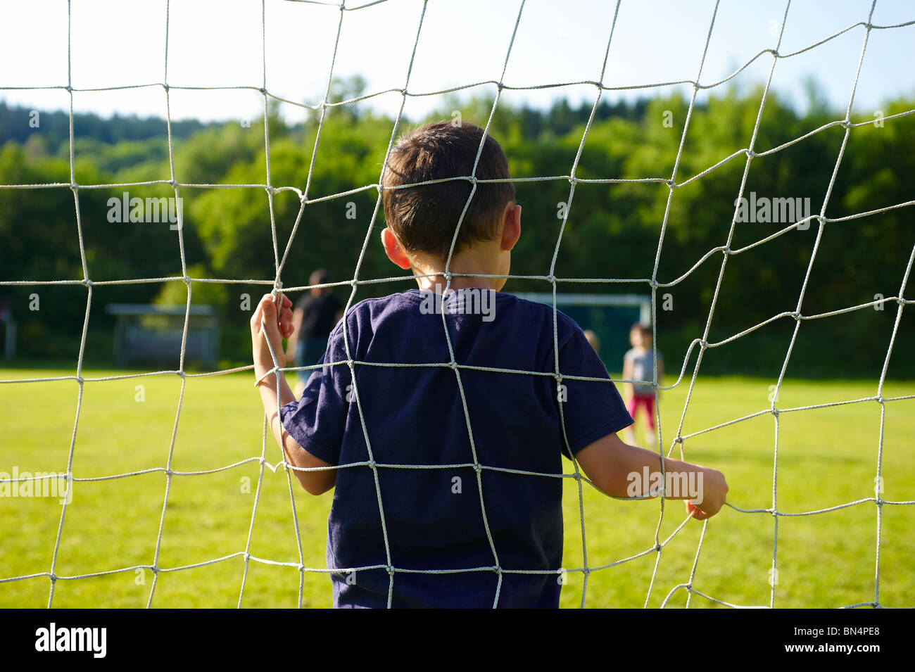 Children playing football on field Stock Photo - Alamy