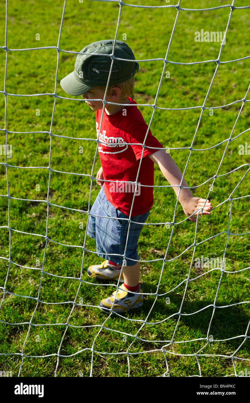 Children playing football on field Stock Photo - Alamy
