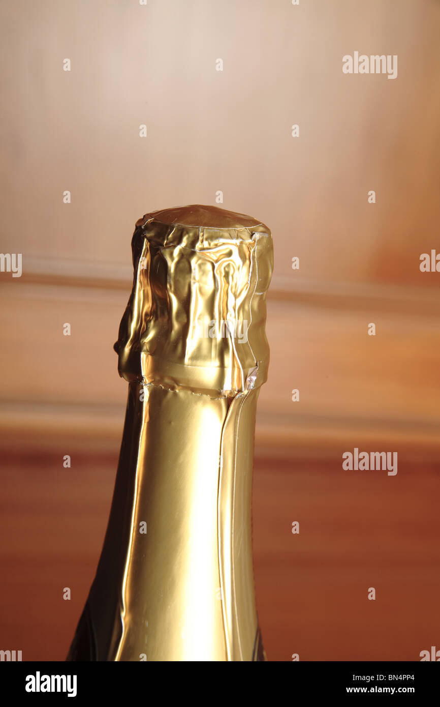 Sealed with golden foil Top of champagne bottle Stock Photo - Alamy