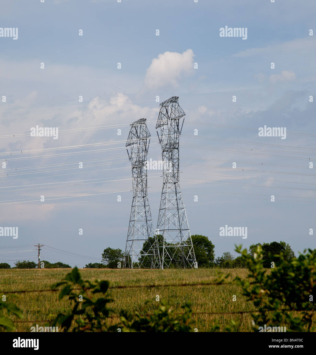 Large metal electricity pylons march across the countryside Stock Photo ...