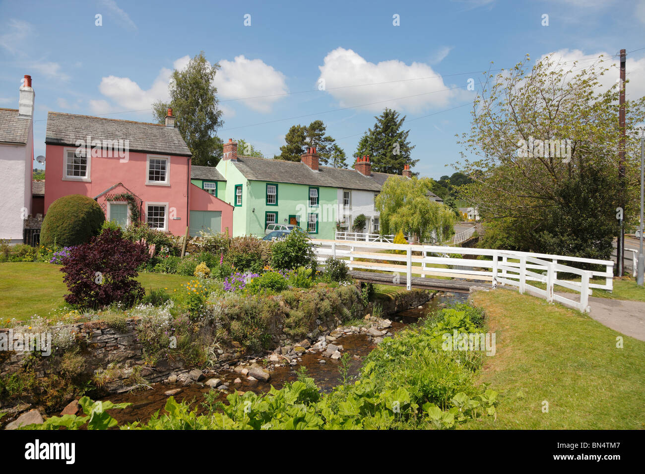 Colourful cottages with stream in front. In Calbeck, The Lake District ...