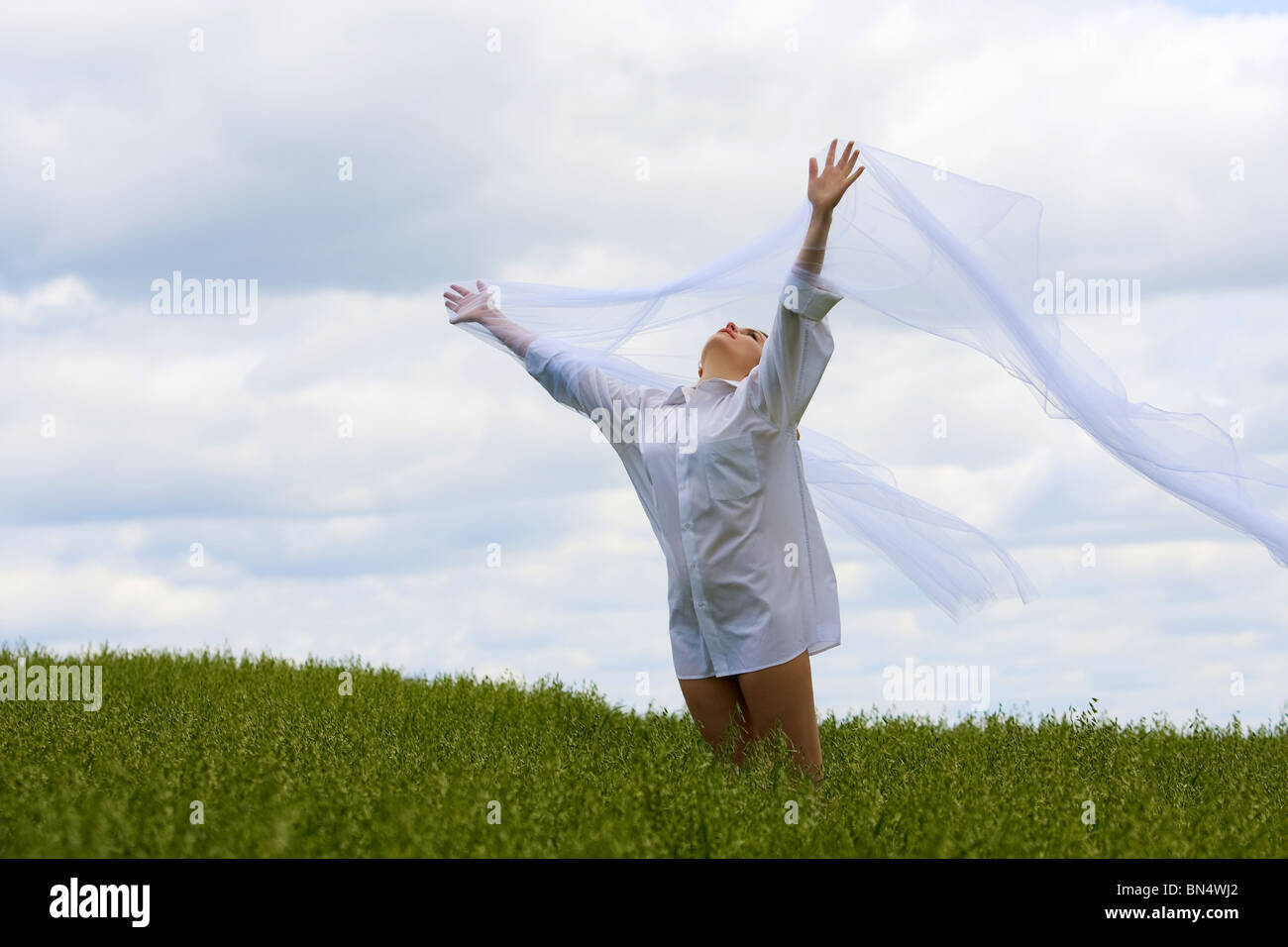 Happy young woman relaxing in a field Stock Photo - Alamy