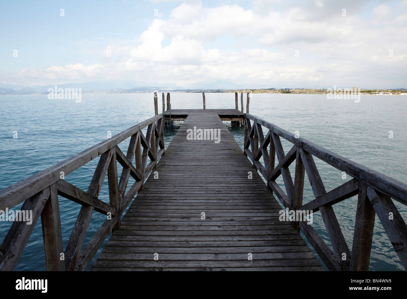 Pretty wooden pier at Lake Garda, Italy Stock Photo - Alamy