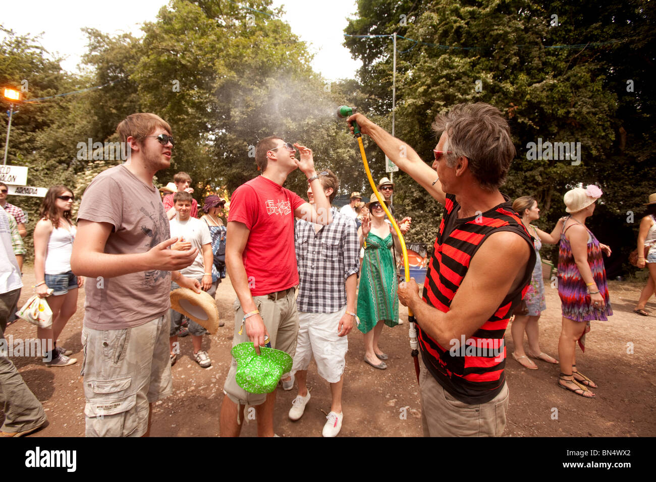 Cooling down under a mist spray gun. Glastonbury Festival 2010 ...