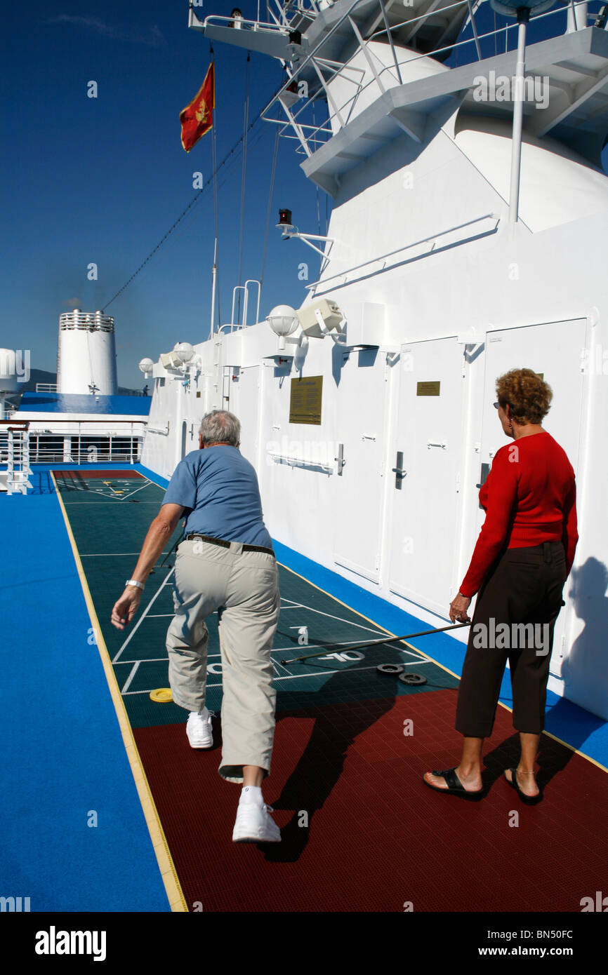 senior couple playing shuffle board on cruise line in the Mediterranean ...