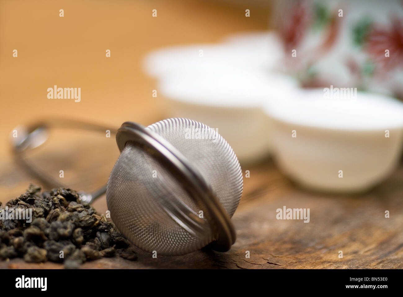 dry green chinese tea set,with strainer closeup,cups and teapot on ...