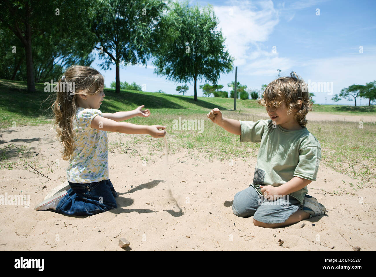 Young children playing in sand at park Stock Photo - Alamy