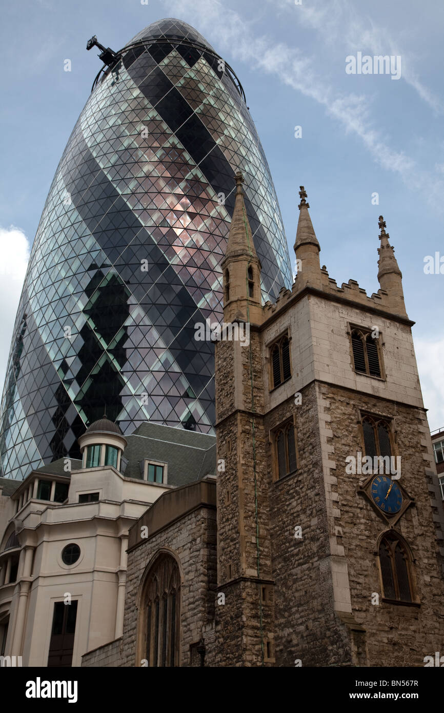 View of 'The Gerkin' building in London behind old church Stock Photo ...