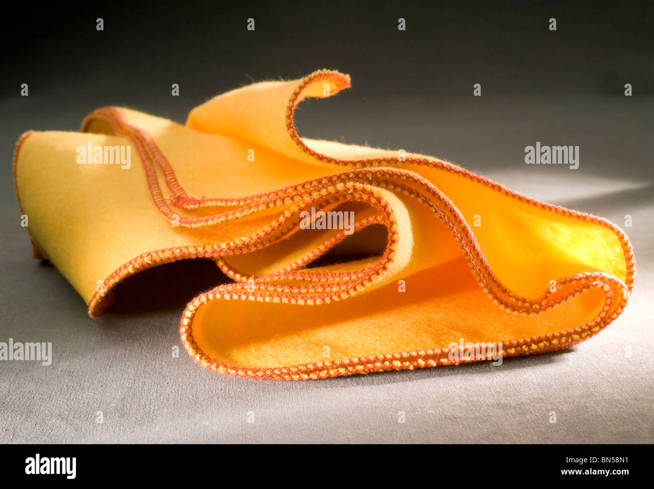 Traditional Yellow duster on grey background Stock Photo - Alamy