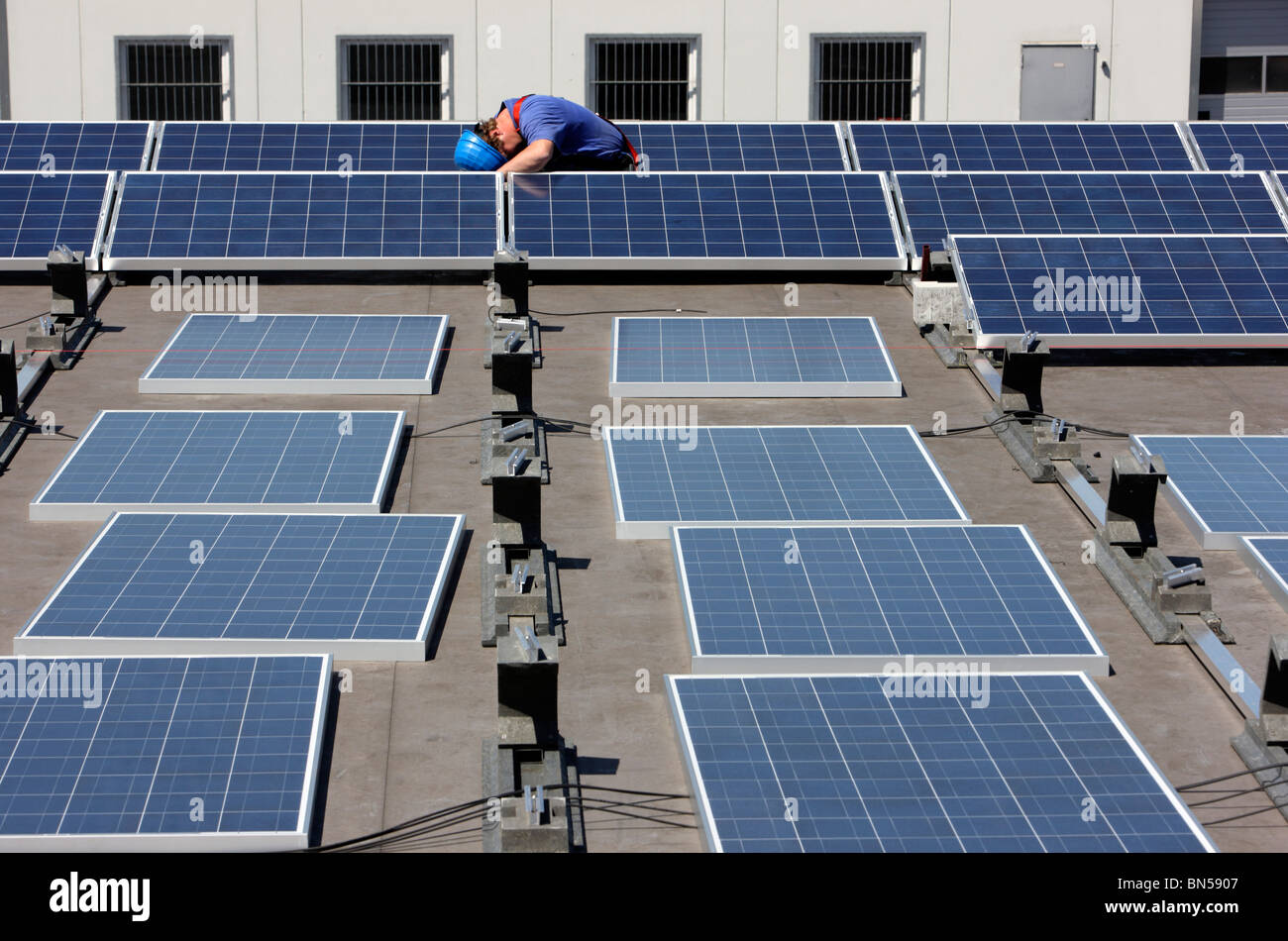 Construction of a big solar power plant, on a huge flat roof of a ...