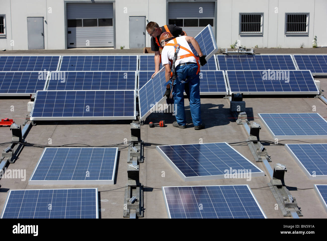 Construction of a big solar power plant, on a huge flat roof of a ...