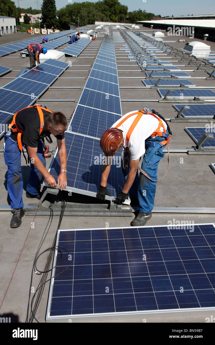 Construction of a big solar power plant, on a huge flat roof of a ...