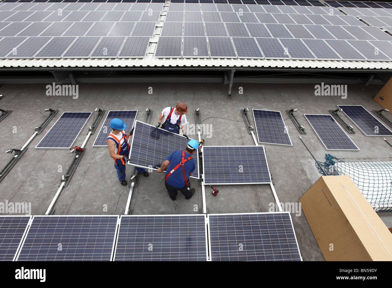 Construction of a big solar power plant, on a huge flat roof of a ...