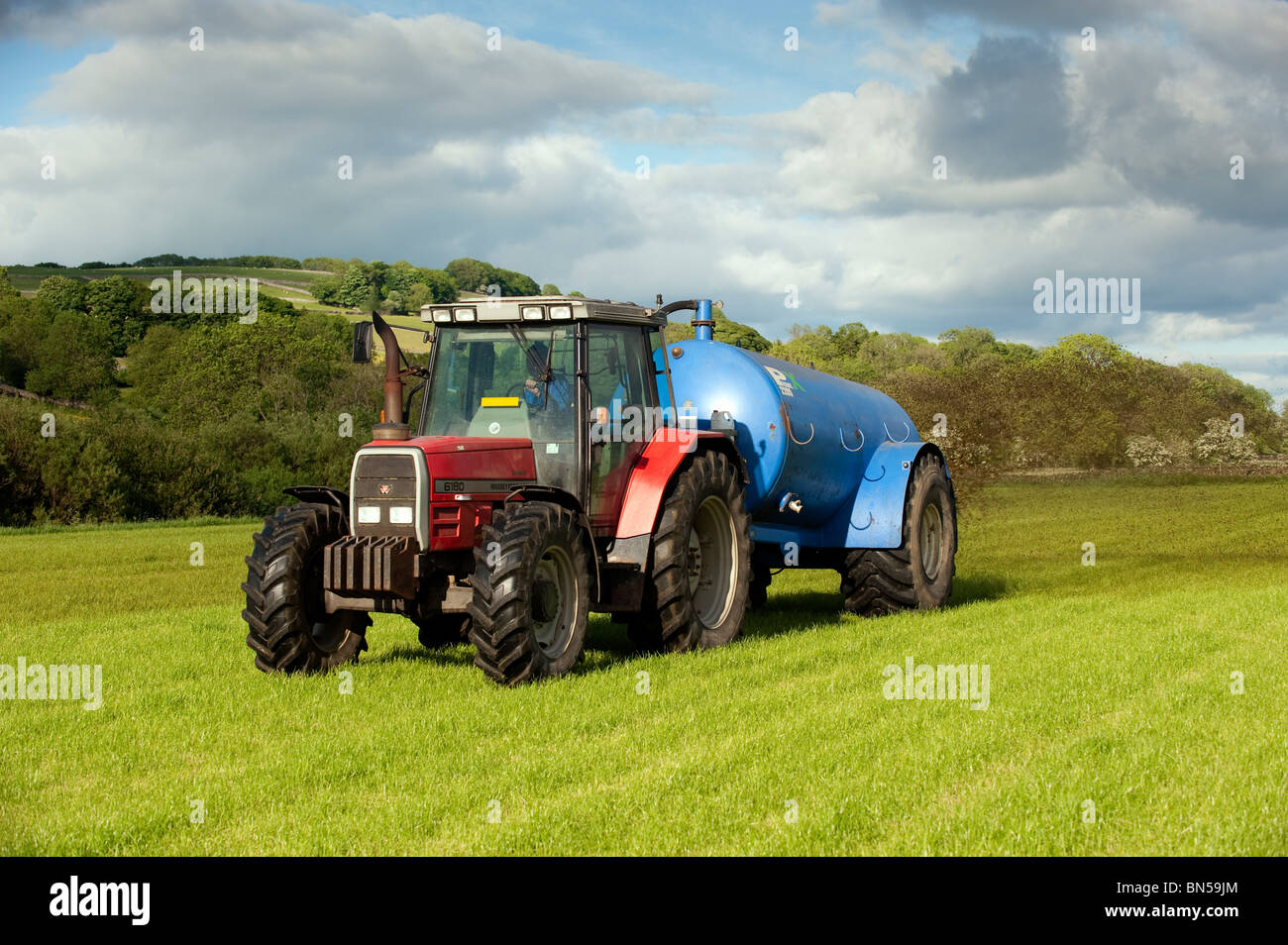 Slurry spreading with a vacum tanker on back of a Massey Ferguson 6180 ...