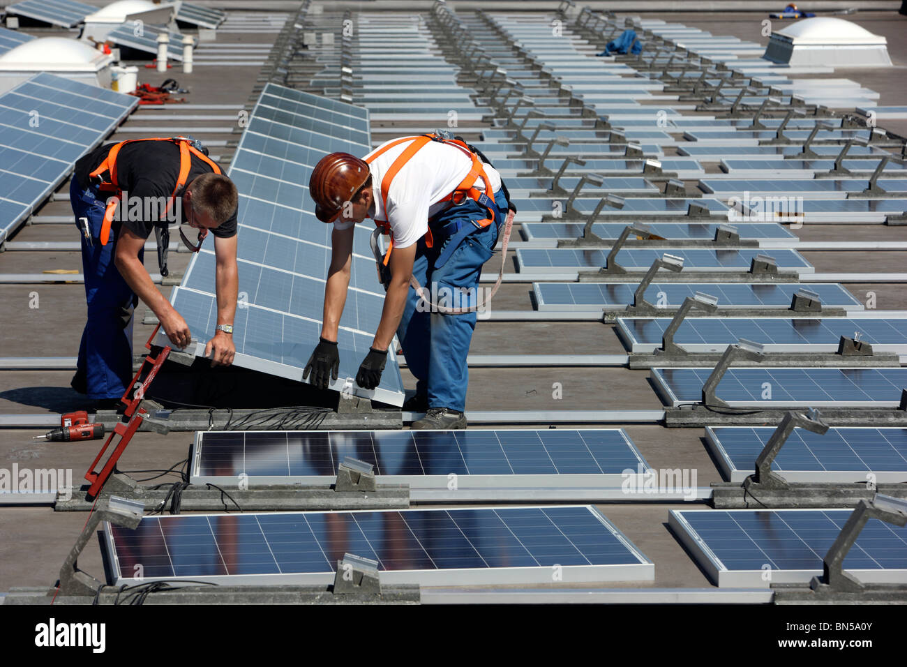 Construction of a big solar power plant, on a huge flat roof of a ...