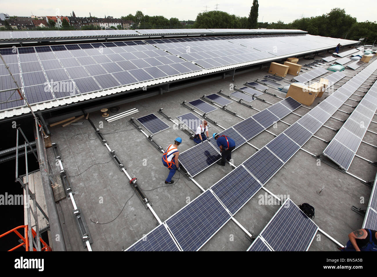 Construction of a big solar power plant, on a huge flat roof of a ...