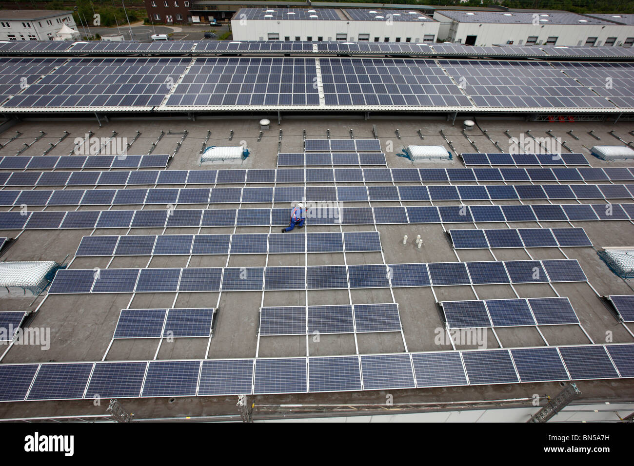 Construction of a big solar power plant, on a huge flat roof of a ...
