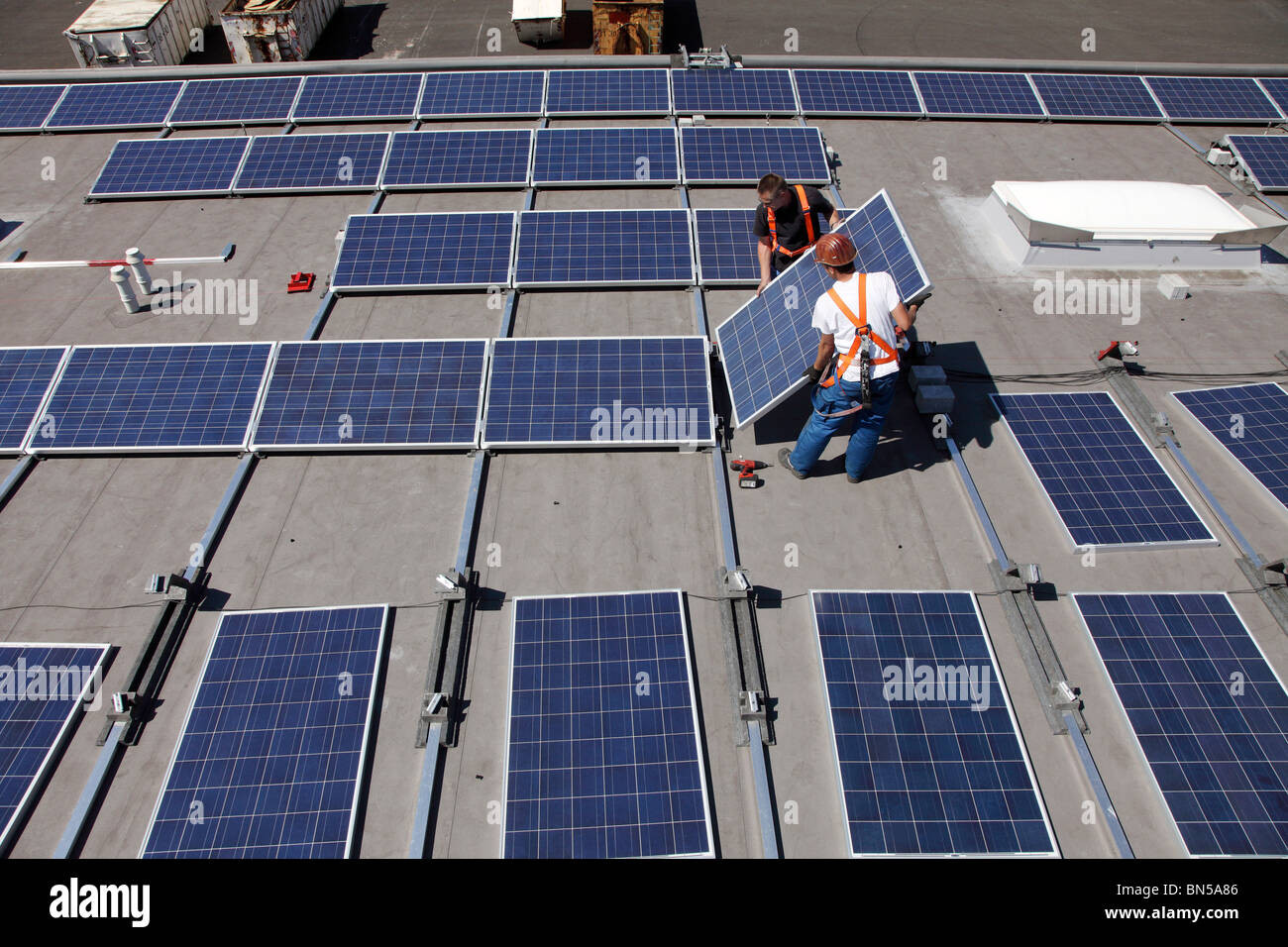Construction of a big solar power plant, on a huge flat roof of a ...