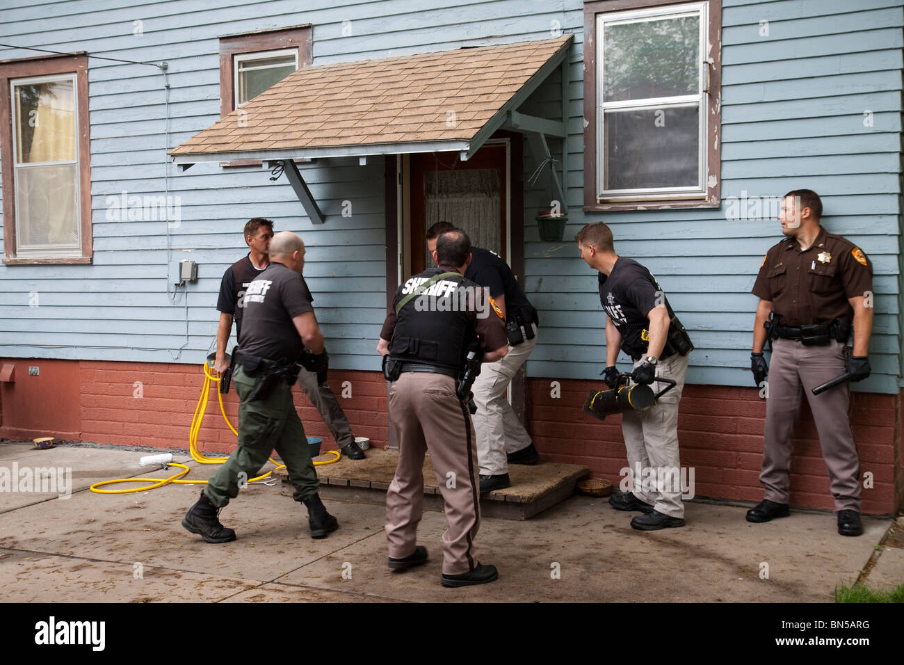 Deputy sheriff's serving drug related search warrant in a rural US ...