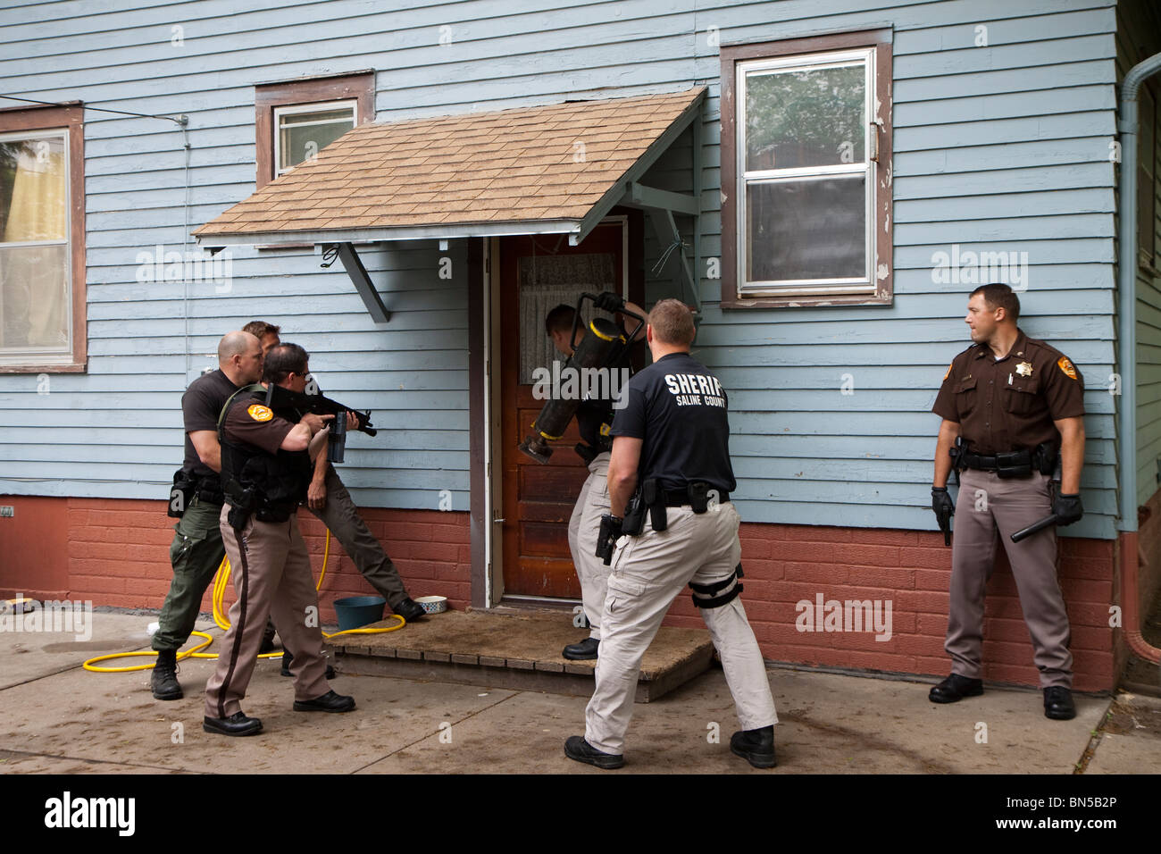 Deputy sheriff's serving drug related search warrant in a rural US ...