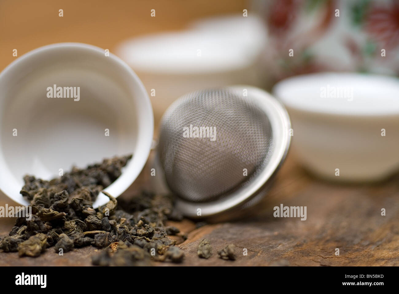 dry green chinese tea set,with strainer closeup,cups and teapot on ...