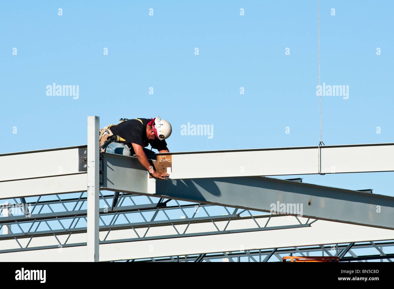 steelworkers erect the structural steel framework for a commercial ...