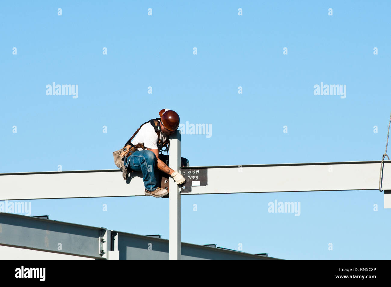 steelworkers erect the structural steel framework for a commercial ...